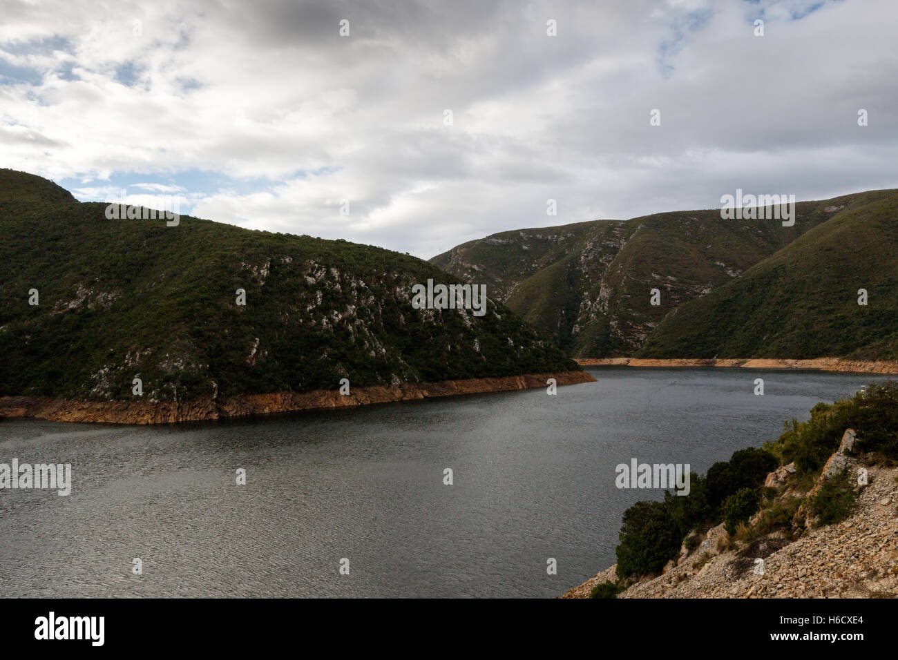 Low water level at the inlet to the Kouga Dam with clouds and valley ...