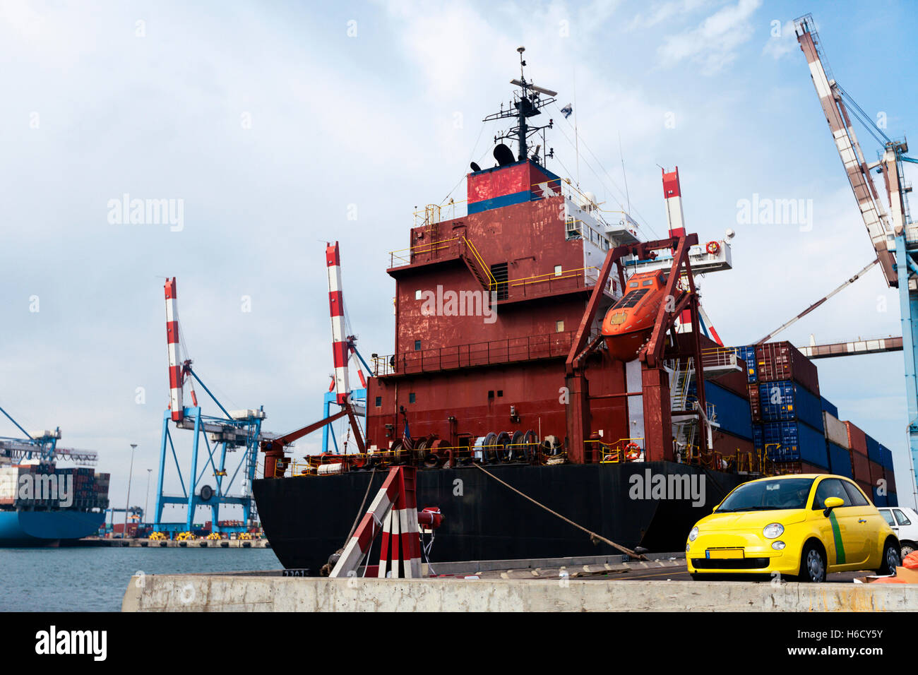 A freighter docking in a commercial harbor, as seen from the bridge of ...
