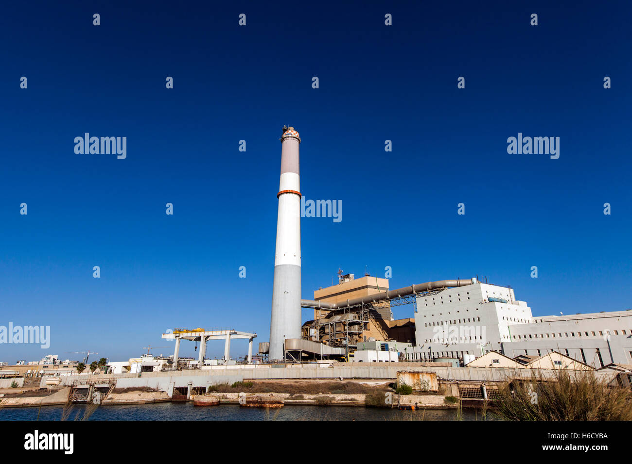 Fossil fuel power plant on a sunny day against clear sky Stock Photo ...