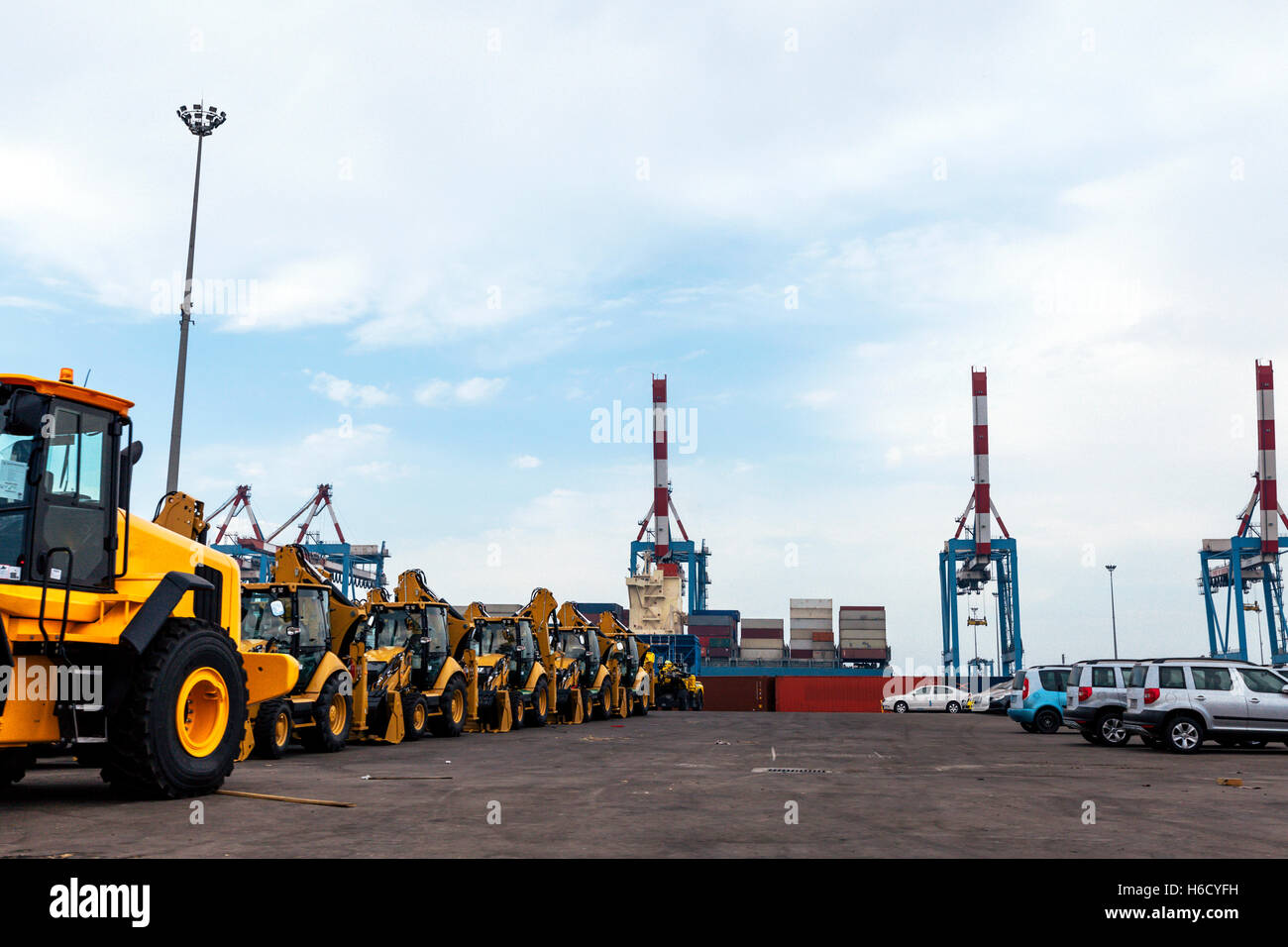 Yellow Earth Movers in a commercial harbor Stock Photo - Alamy