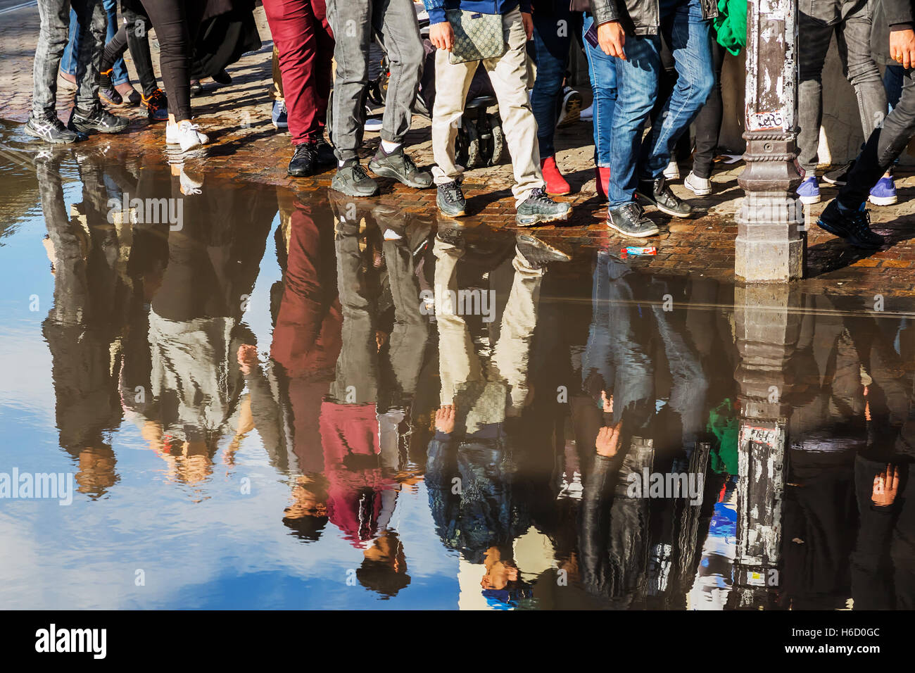 crowd of people on the move in the city, reflecting in a puddle Stock ...