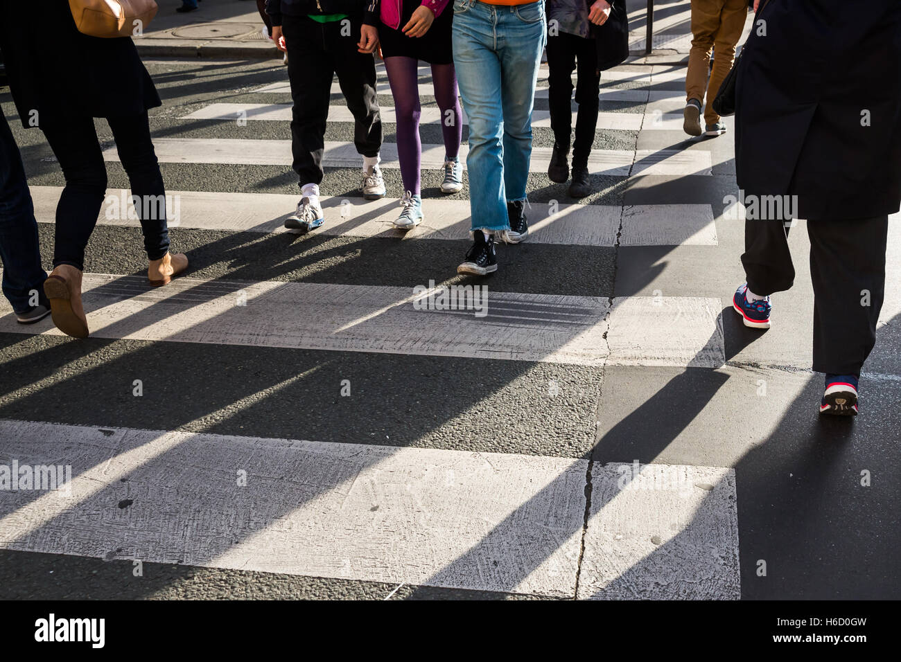 crowd of people crossing a street at the pedestrian crossing Stock ...