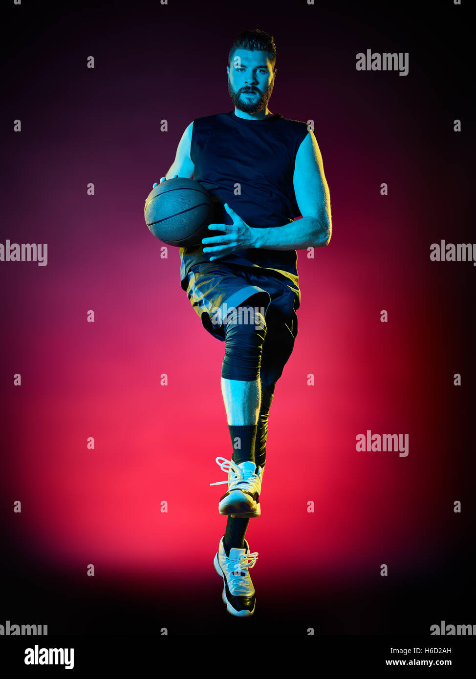 one basketball player man Isolated on black background Stock Photo - Alamy