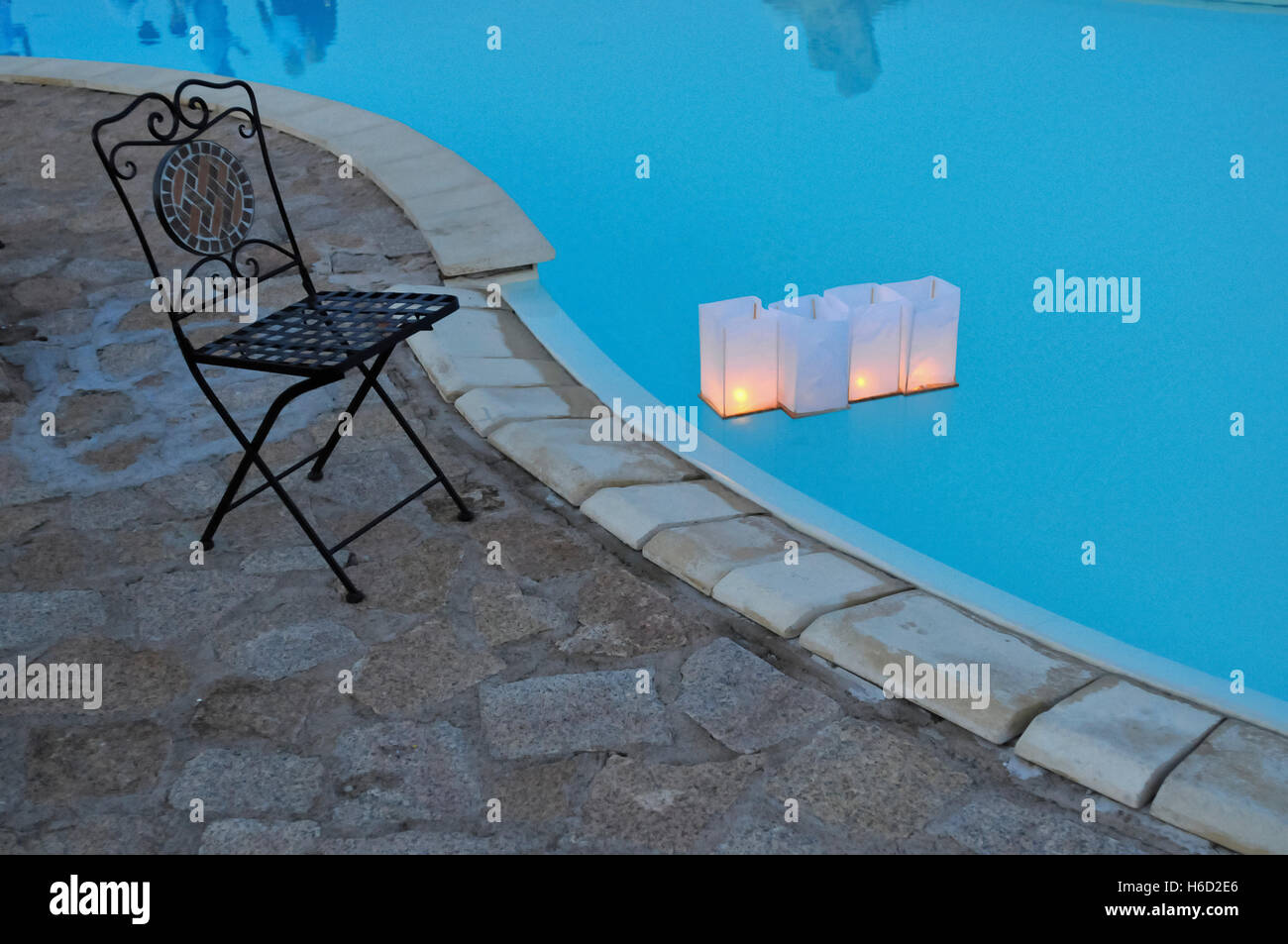 Chair By Poolside night Stock Photo - Alamy