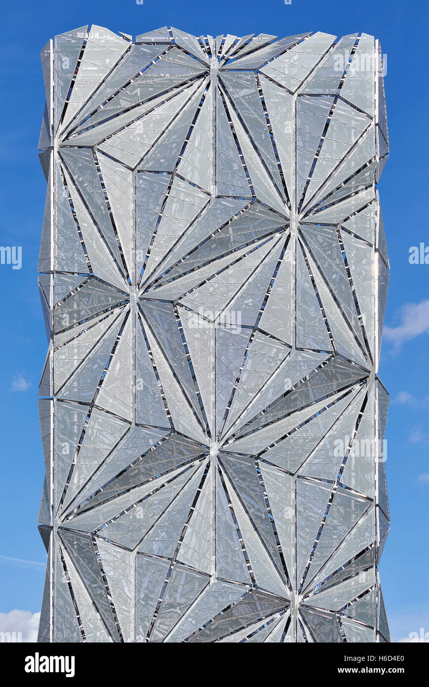 Face on view of the sculptural chimney with faceted abstract panels ...