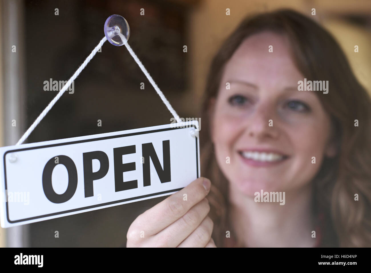 Store Owner Turning Open Sign In Shop Doorway Stock Photo - Alamy