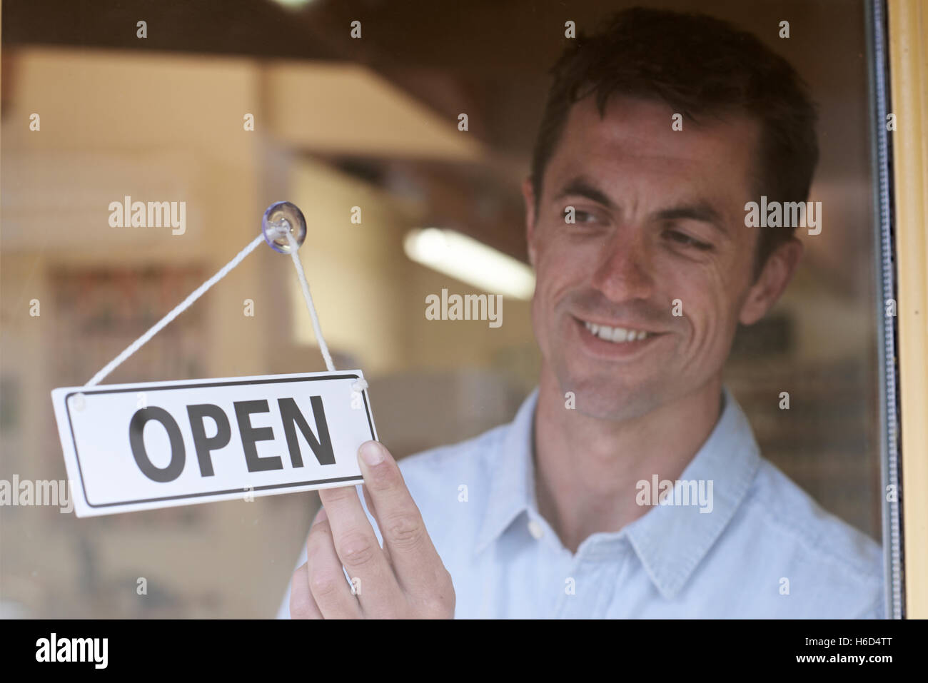 Store Owner Turning Open Sign In Shop Doorway Stock Photo - Alamy