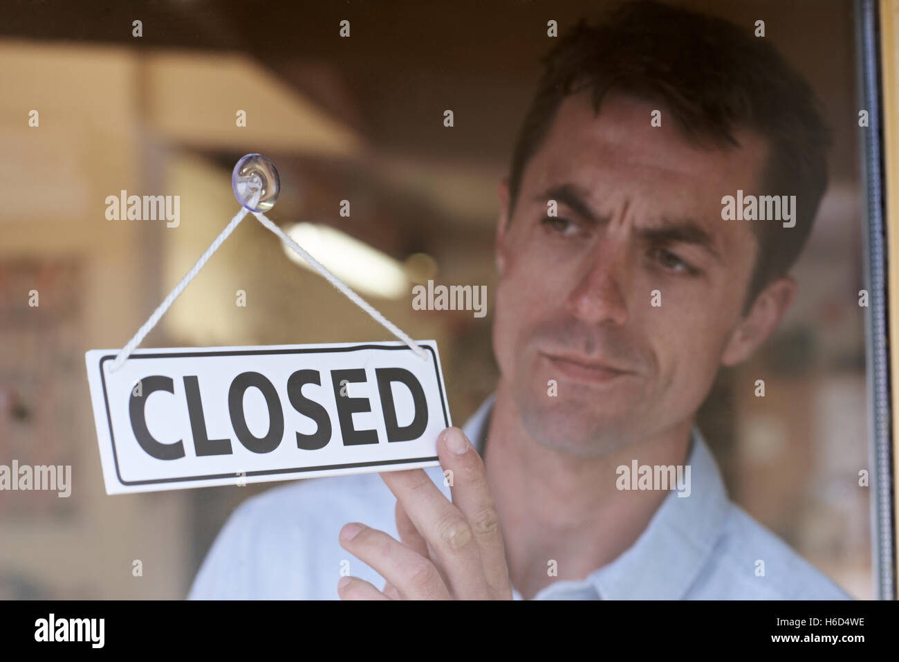 Store Owner Turning Closed Sign In Shop Doorway Stock Photo - Alamy