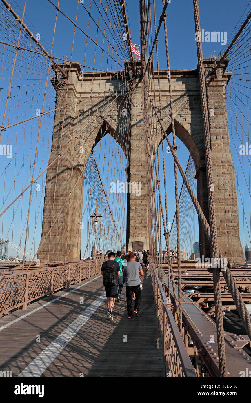The Brooklyn Bridge walkway and one of the brick towers in the middle ...