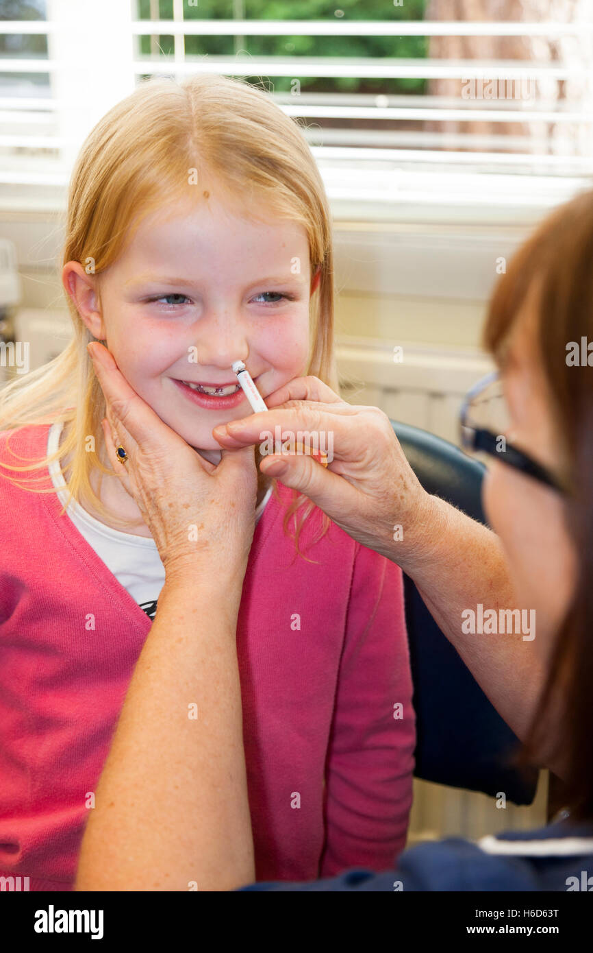 Six / 6 year old child receives dose of Fluenz flu vaccine nasal spray ...