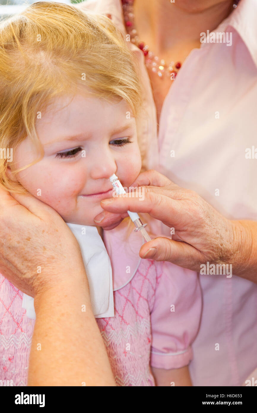 2 year old child, with her mum / mother, receives dose of Fluenz flu ...