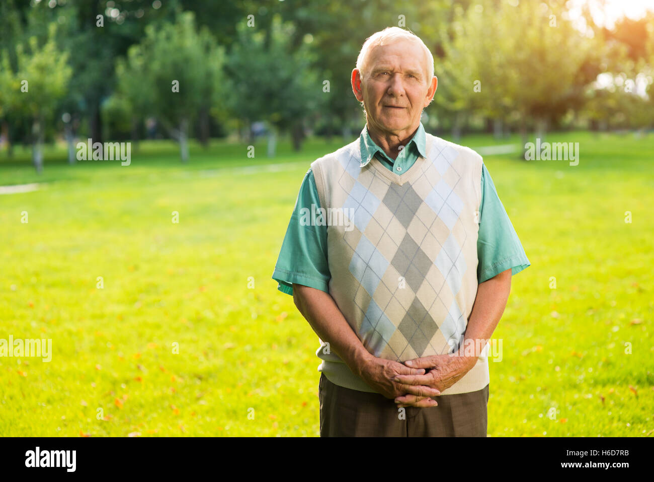 Senior man standing outdoors Stock Photo - Alamy