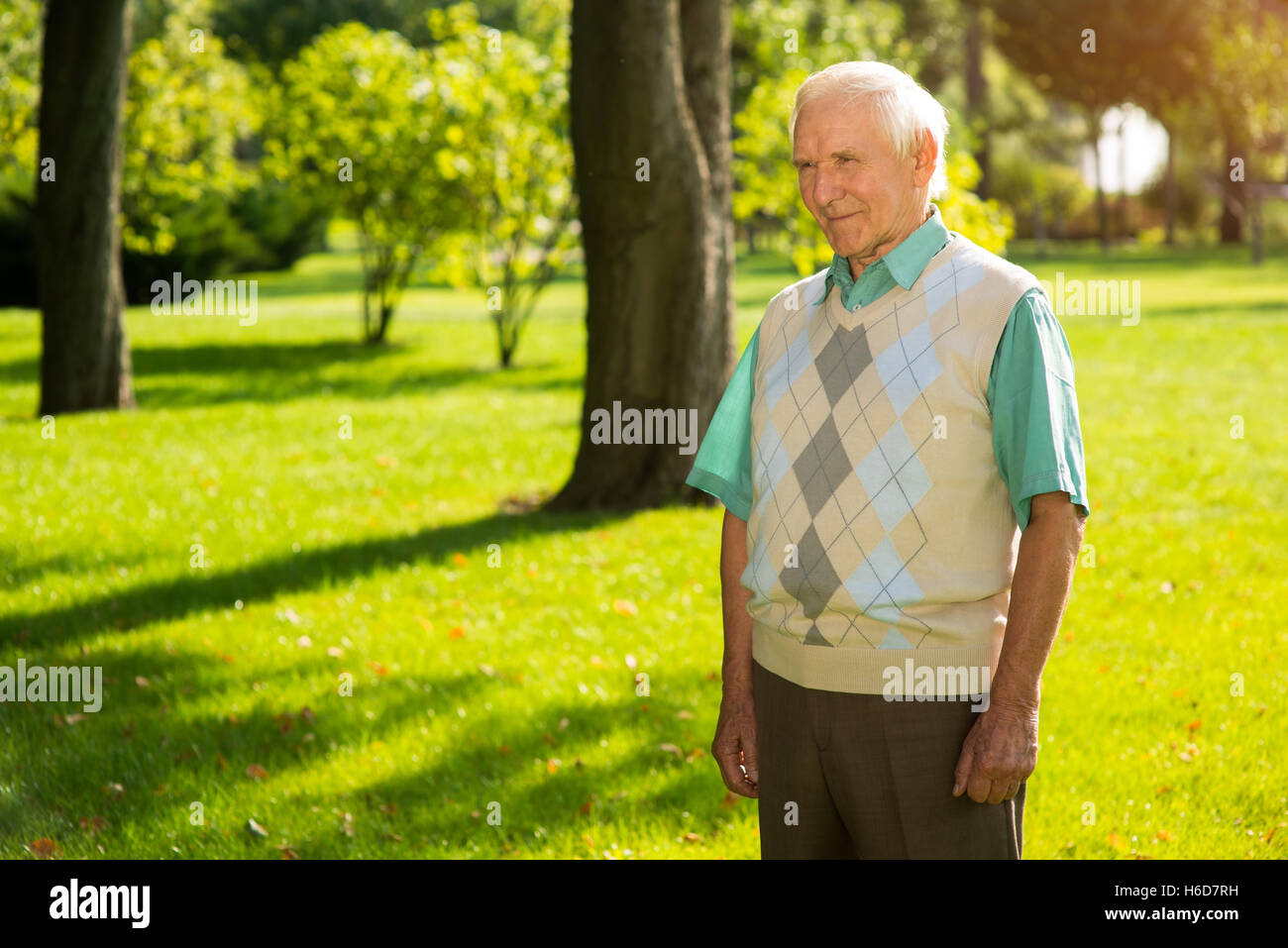 Elderly man standing outdoor Stock Photo - Alamy