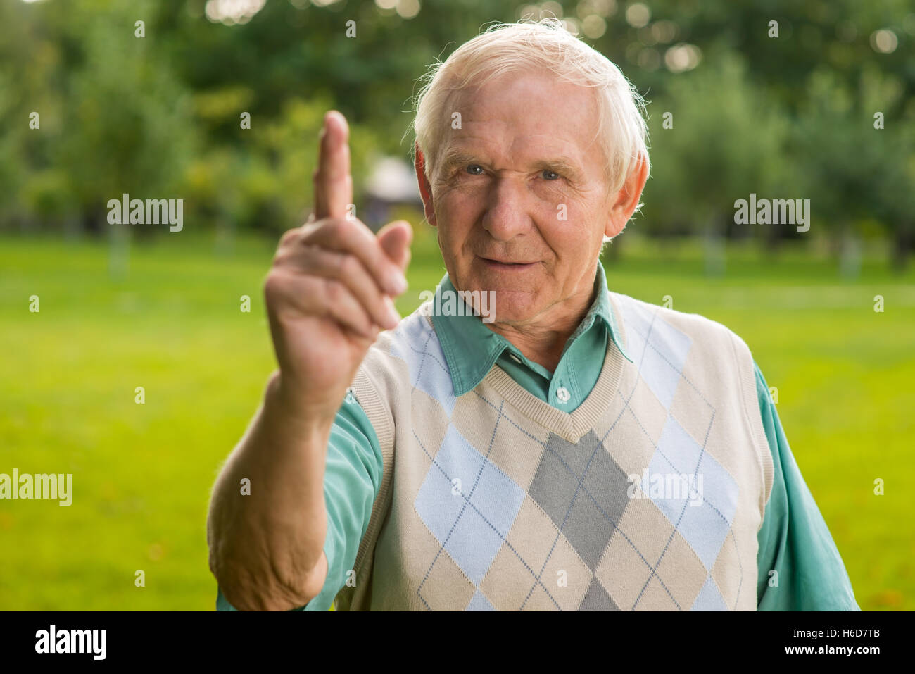 Man with raised finger Stock Photo - Alamy