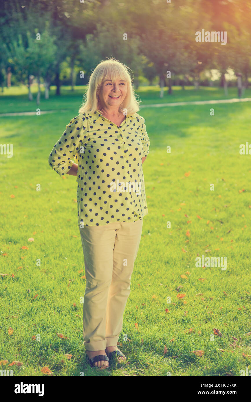Woman with hands behind back Stock Photo - Alamy