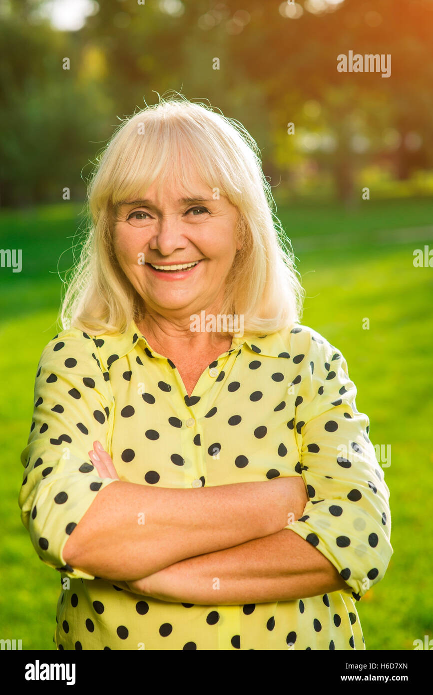 Lady with crossed arms smiling Stock Photo - Alamy