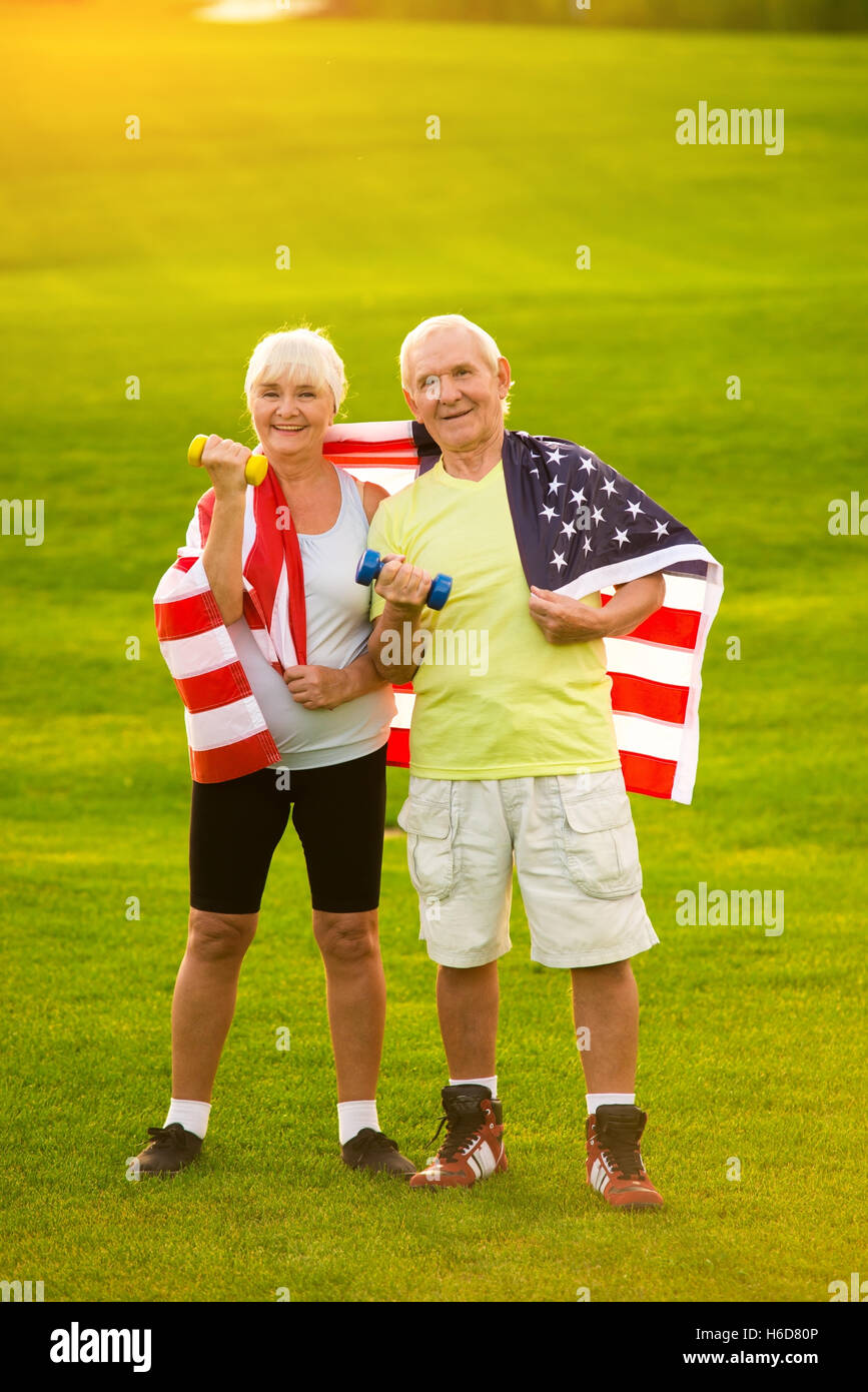 Couple wrapped in American flag Stock Photo - Alamy