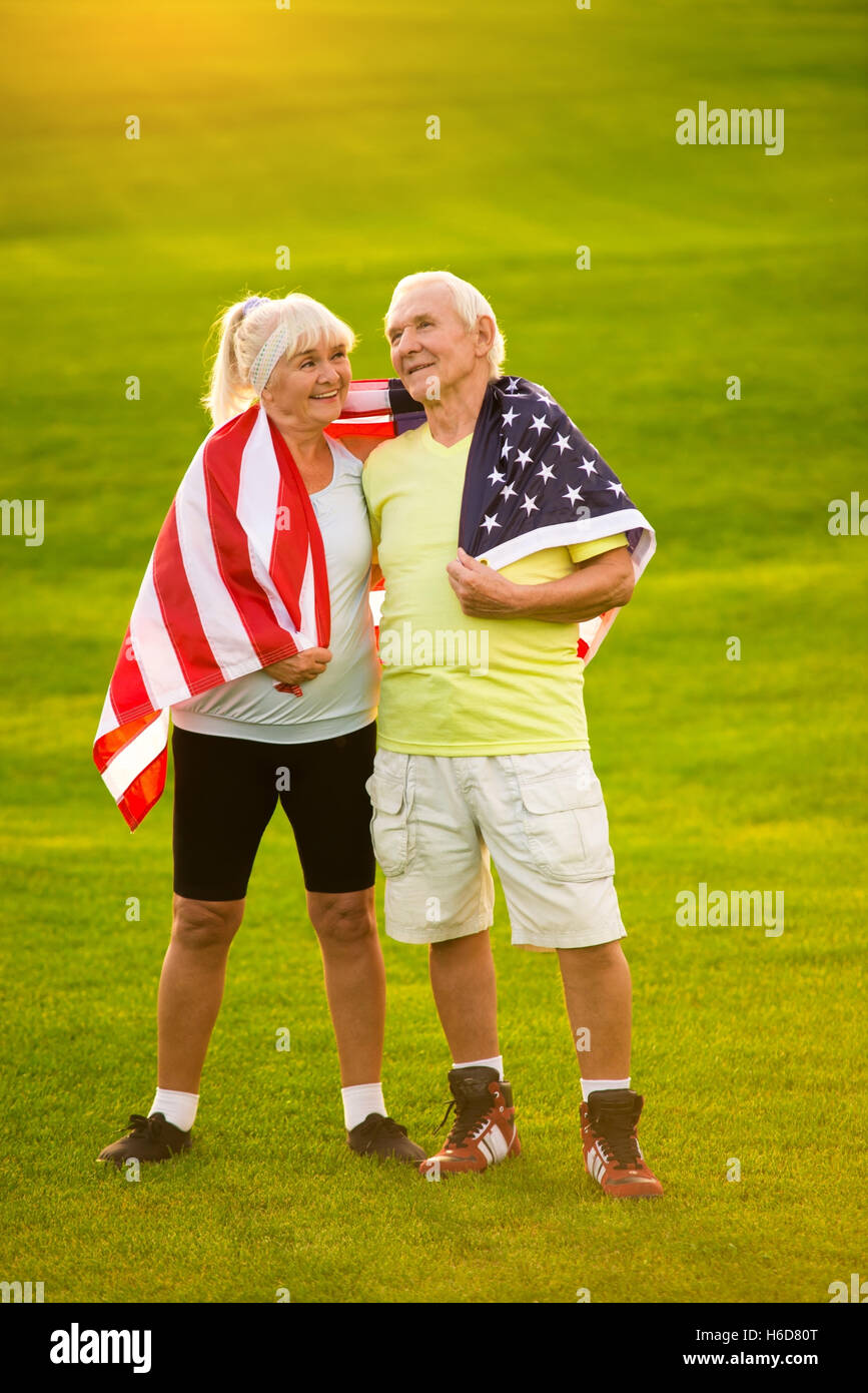 Couple wrapped in USA flag Stock Photo - Alamy