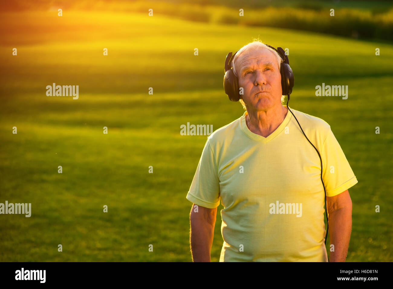 Elderly man in headphones Stock Photo - Alamy