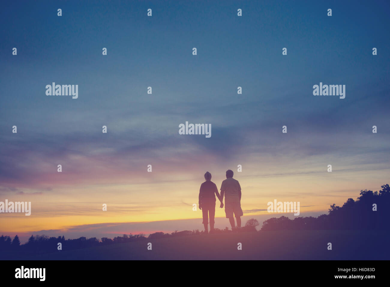 Couple on background of sunset Stock Photo - Alamy