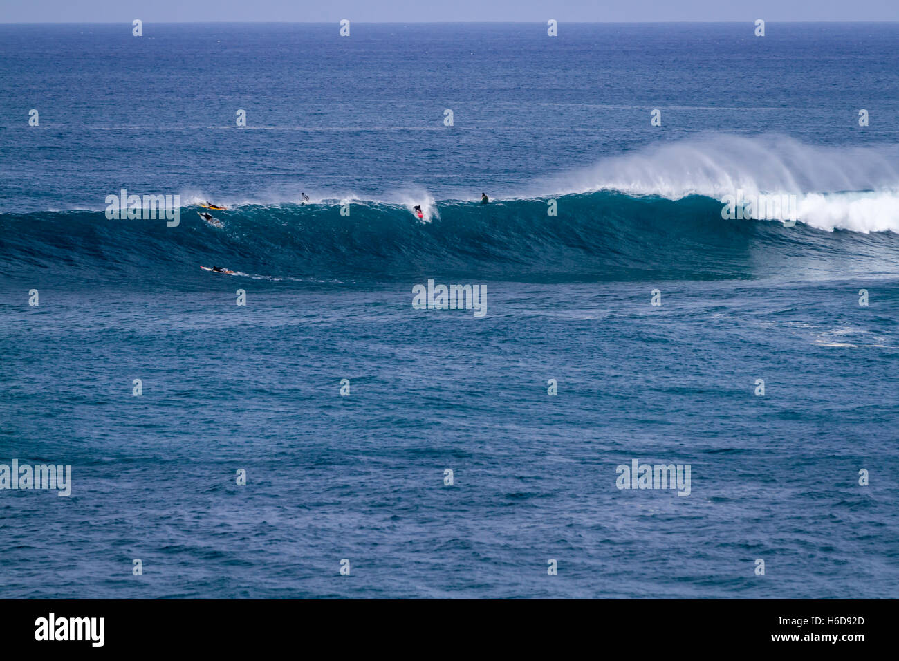 Surfing waves at Waimea Bay on the north shore of Oahu Hawaii USA April ...