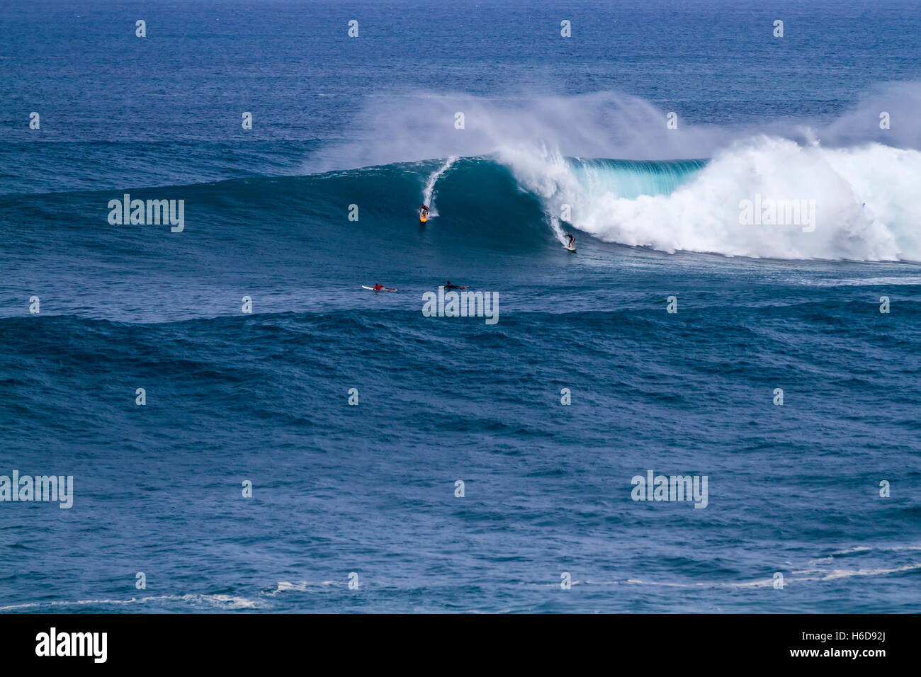Surfing waves at Waimea Bay on the north shore of Oahu Hawaii USA April ...
