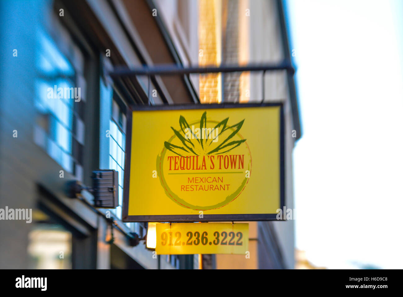 Colorful yellow metal Sign hangs over entrance for the Tequila's Town ...