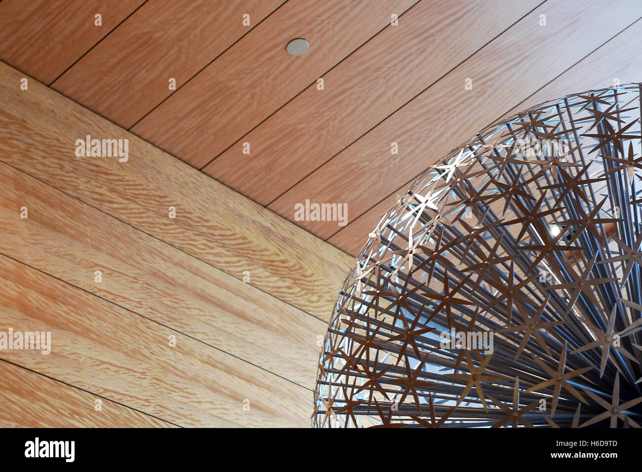 The silver metal circle decoration and wooden textured wall backround ...