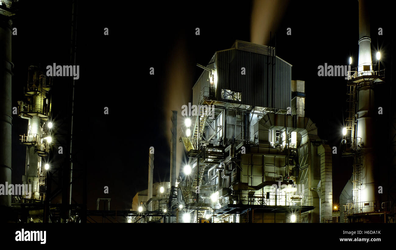 The oil refinery building at night time Stock Photo - Alamy