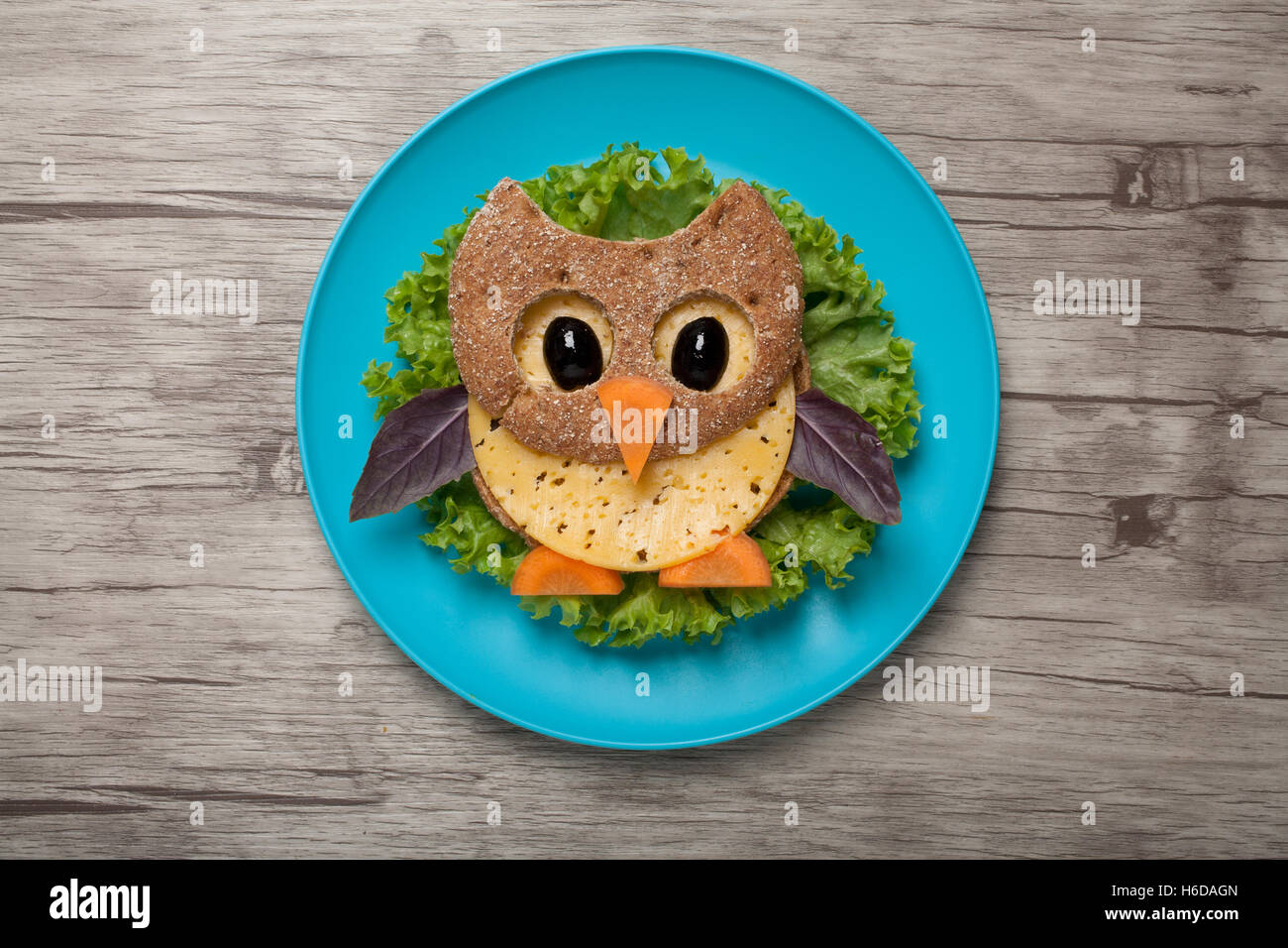 Owl made of bread and cheese on plate and board Stock Photo - Alamy