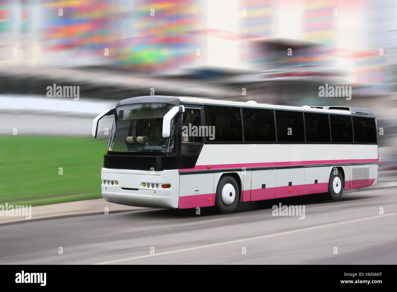 The tourist bus quickly going on a city Stock Photo - Alamy