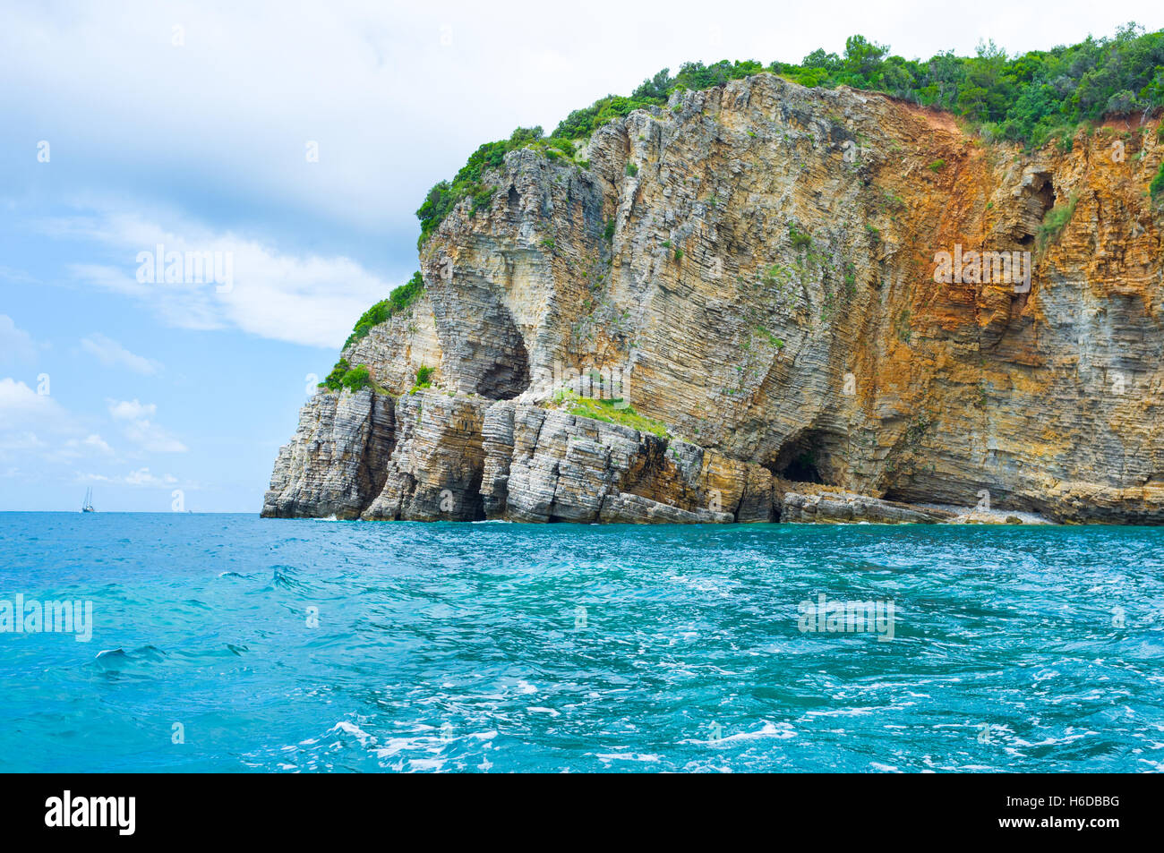 The high cliffs next to the central beach of Budva make the coastline ...