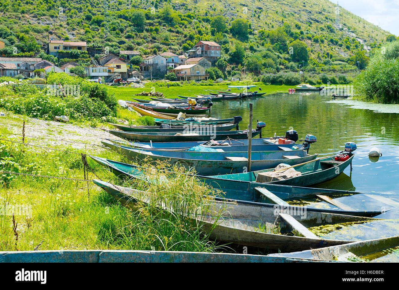 The port on Moraca River in Vranjina fishing village with many moored ...