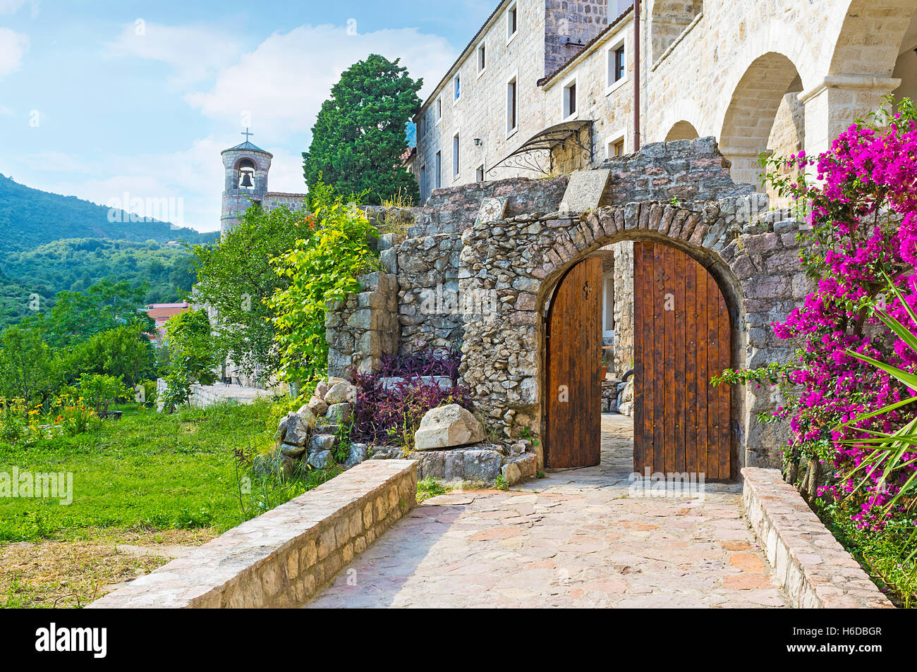 The wooden gate, surrounded by flowers, leads to the living side of ...