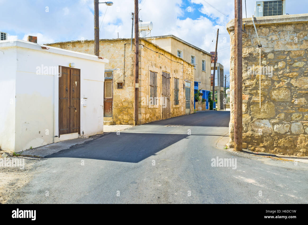The narrow street with the medieval houses in Neo Chorio village ...
