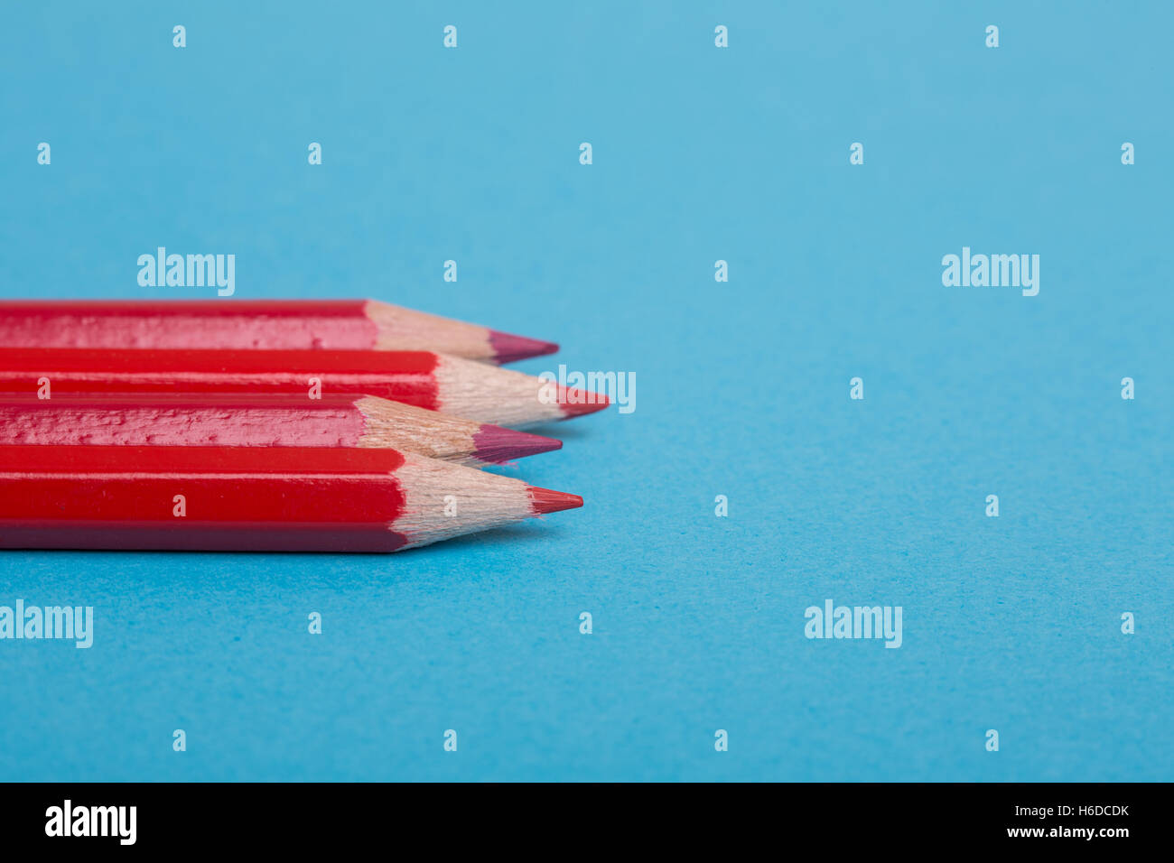 Wooden red pencils, on a blue background Stock Photo - Alamy