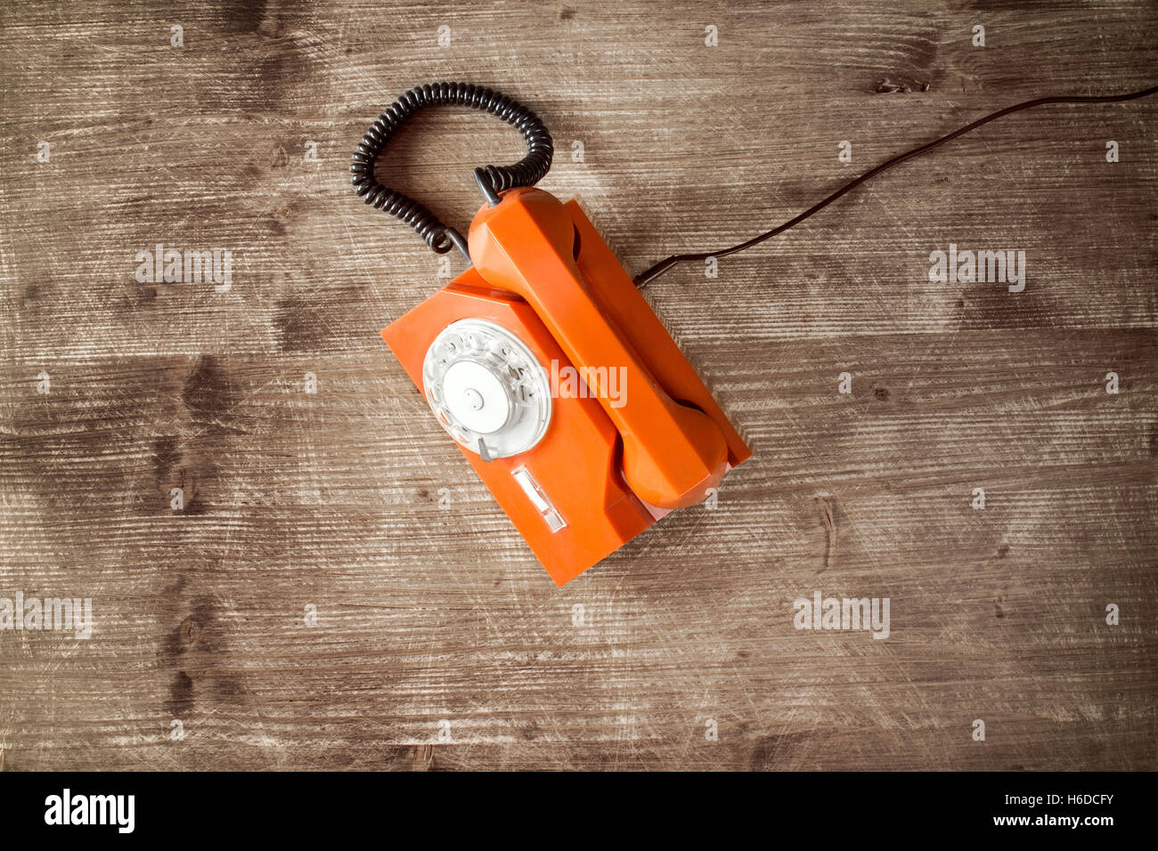 Old orange retro phone with rotary dial Stock Photo - Alamy