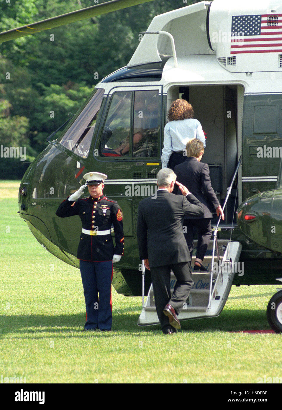 United States President Bill Clinton salutes the Marine Guard as he and ...