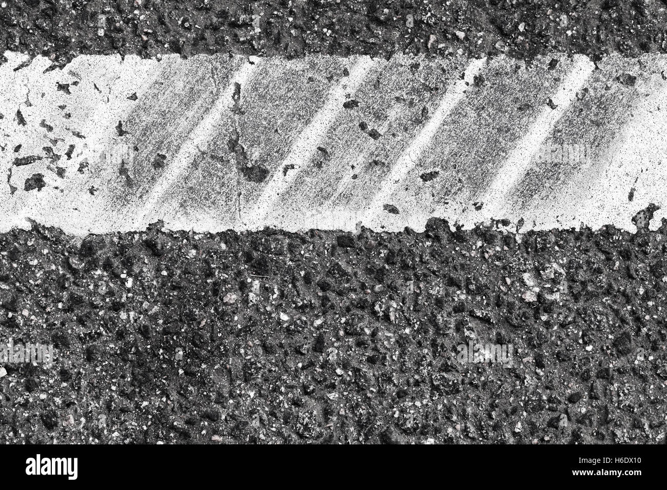 White dividung line fragment with tire tracks over it, highway road ...