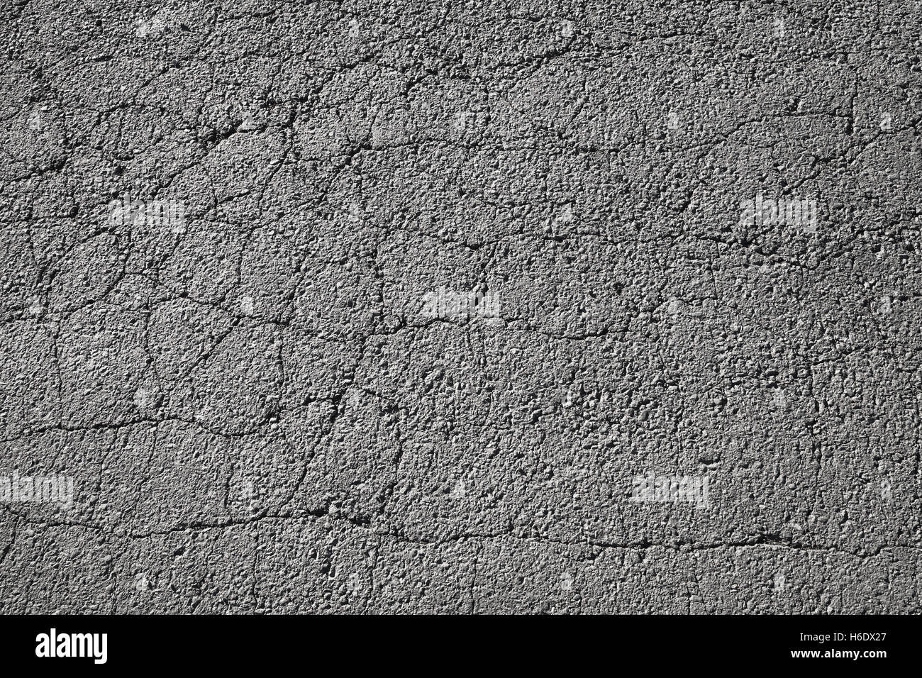 Tarmac. Cracked dark road pavement consisting of crushed rock mixed ...