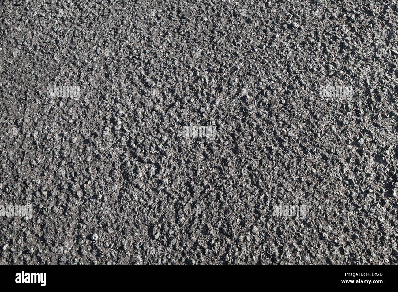 Tarmac. Dark road pavement consisting of crushed rock mixed with tar ...