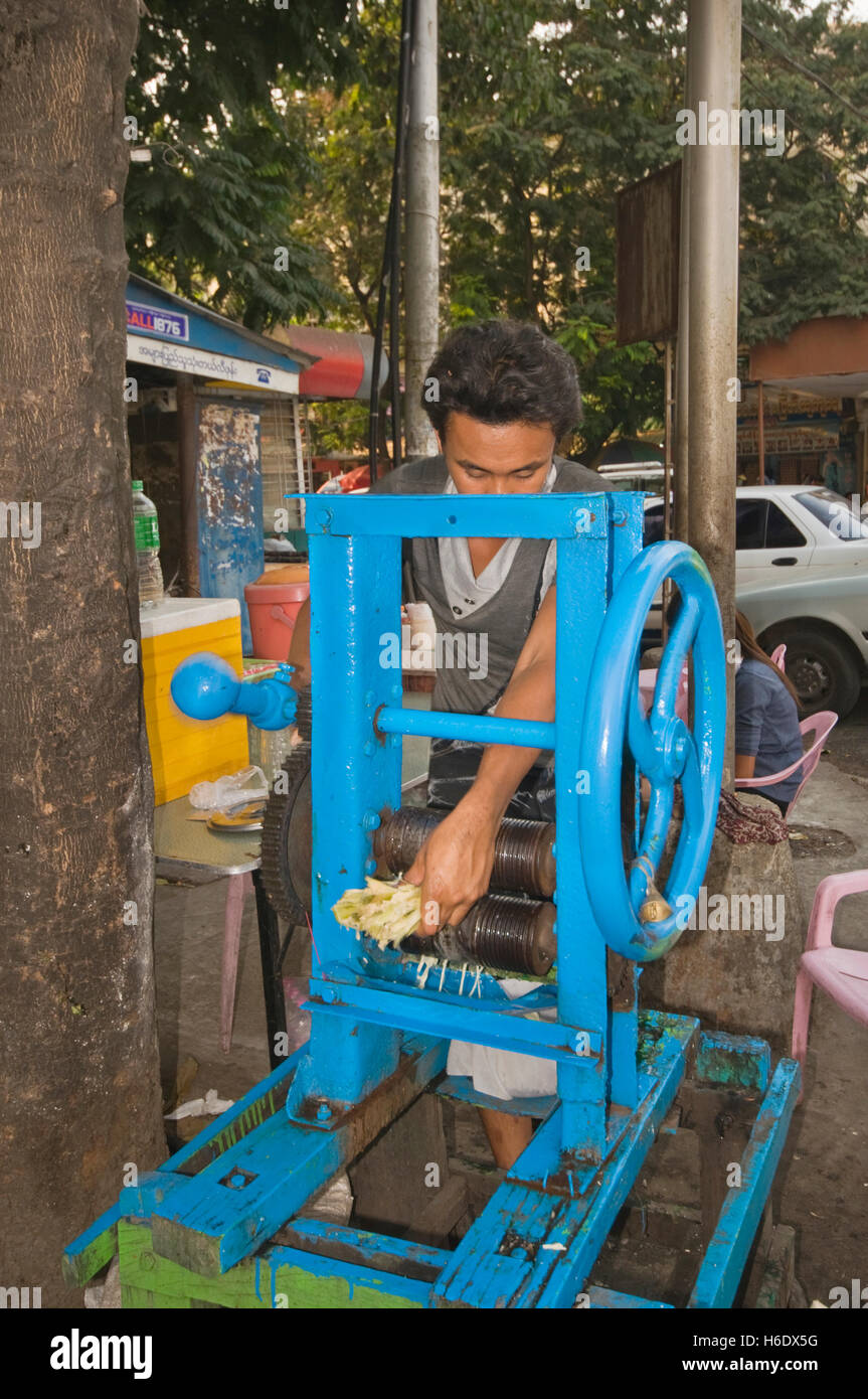 ASIA, MYANMAR (BURMA), Yangon (Rangoon), man squeezing sugar cane on ...