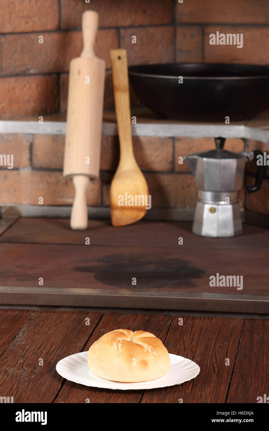Kaiser roll on paper plate at rural kitchen background Stock Photo - Alamy
