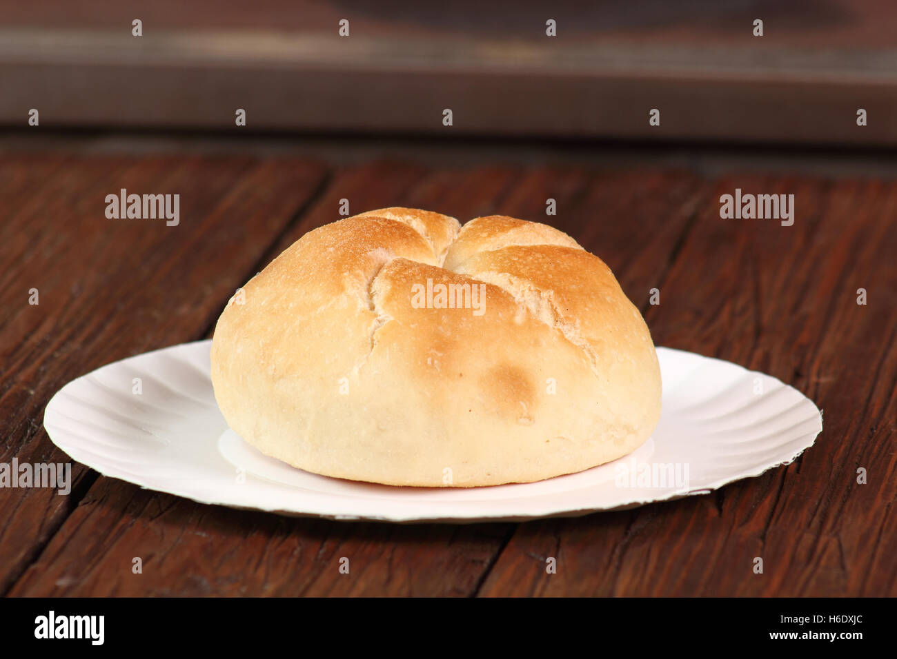 Kaiser roll on paper plate Stock Photo - Alamy