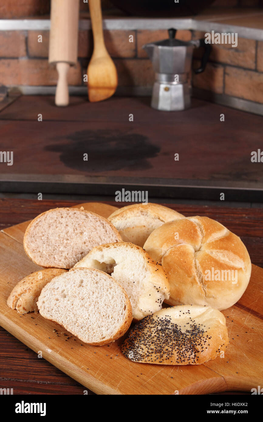 Assortment of sliced bread rolls at rural kitchen background Stock ...