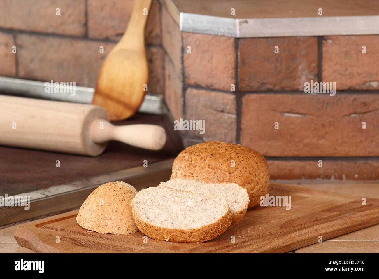 Sliced Graham bread rolls at rural kitchen background Stock Photo - Alamy