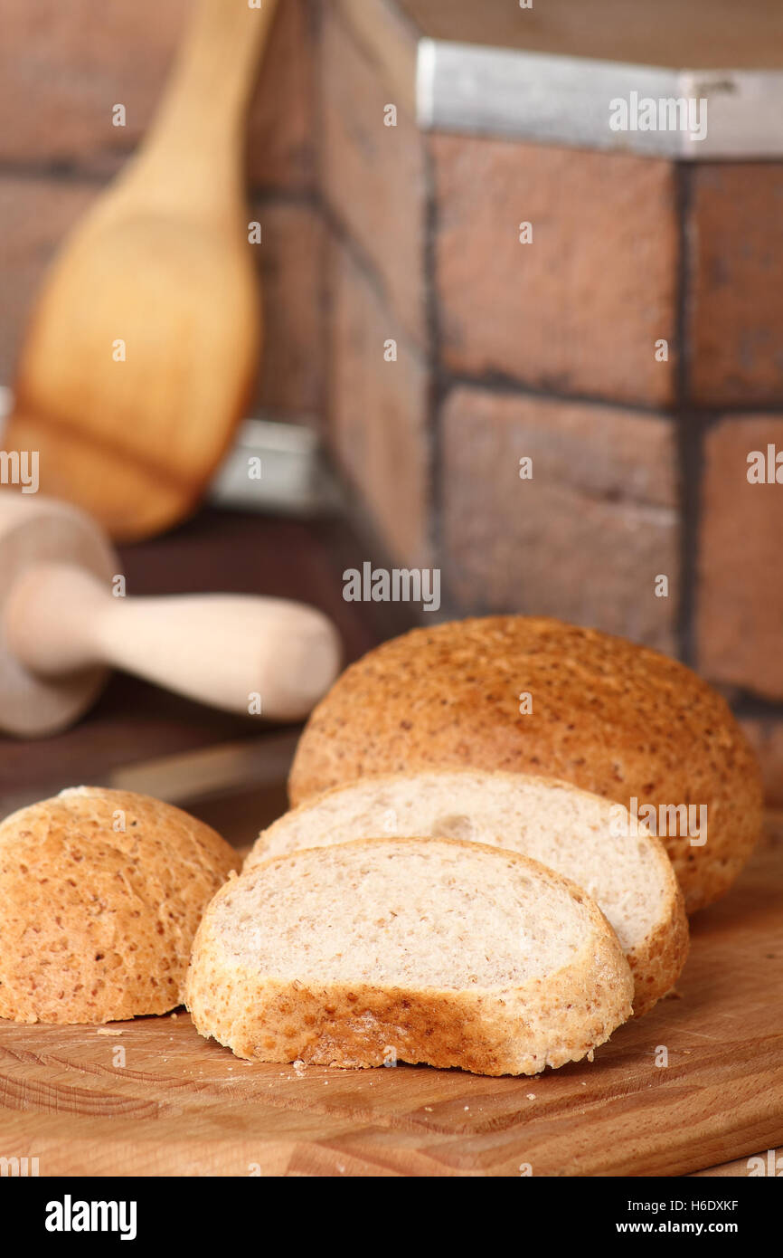 Sliced Graham bread roll at rural kitchen background Stock Photo - Alamy