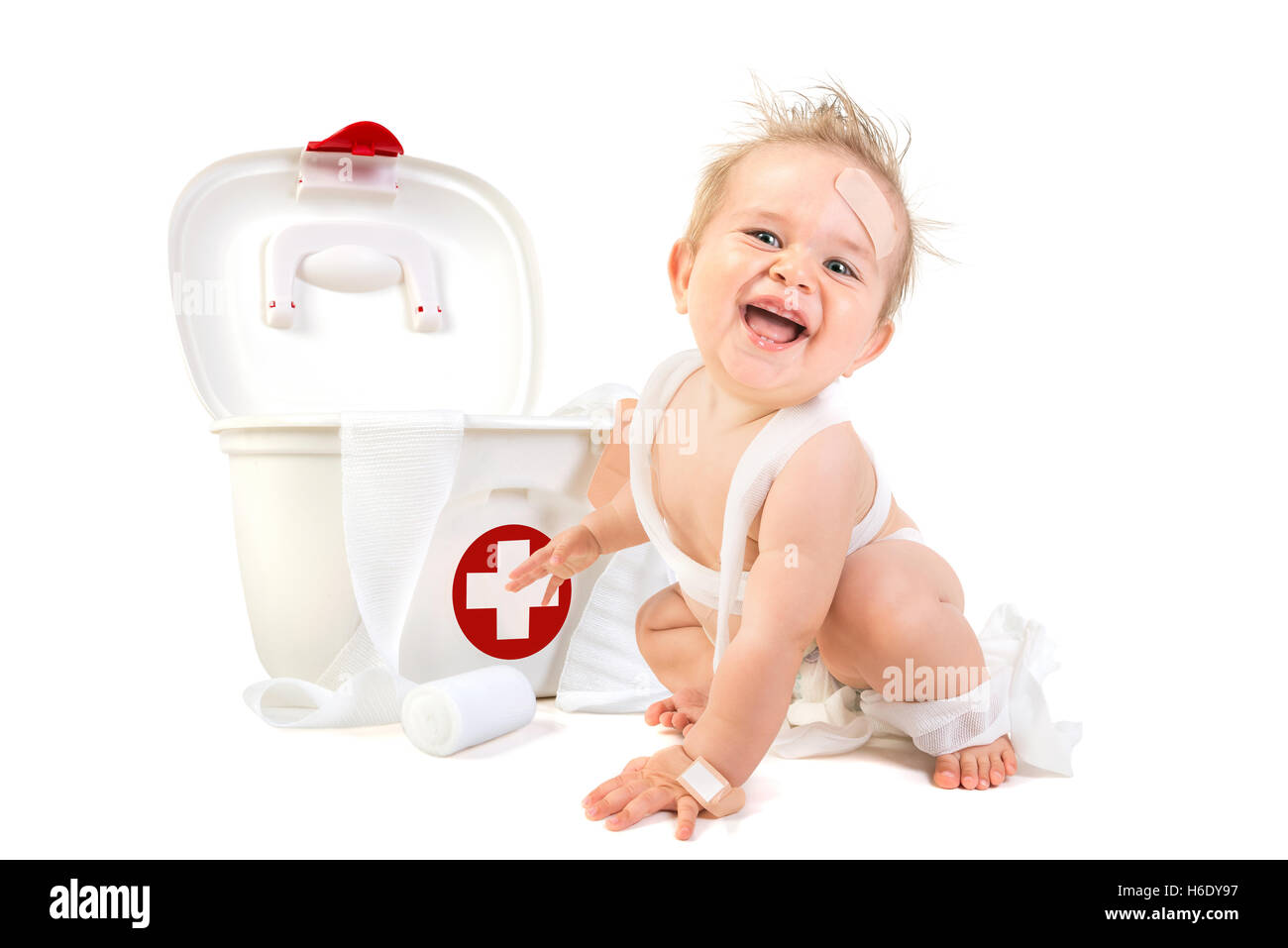 Cute baby boy playing with bandages in a first aid kit box Stock Photo ...
