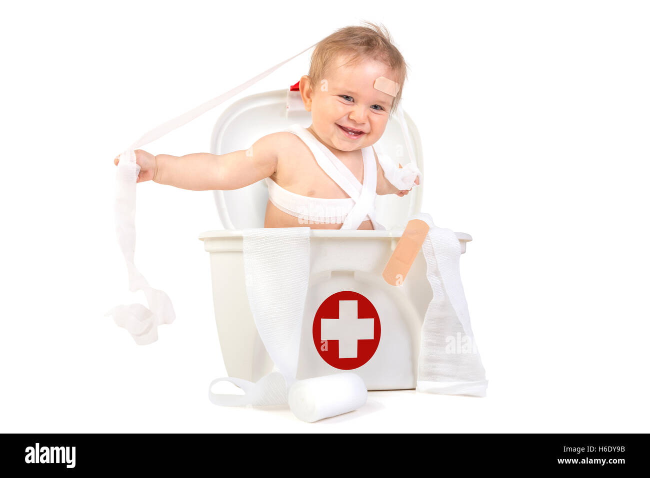 Cute baby boy playing with bandages in a first aid kit box Stock Photo ...