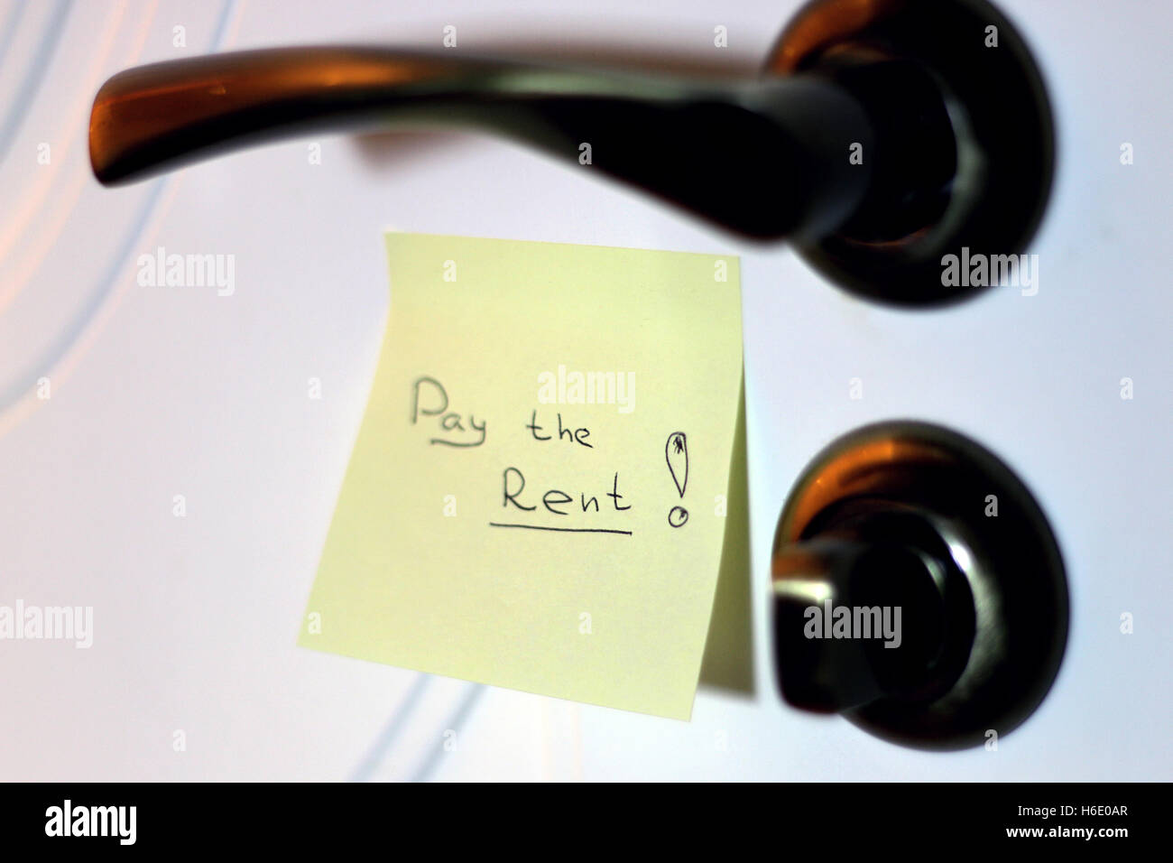 Note by the door Pay Rent Stock Photo - Alamy
